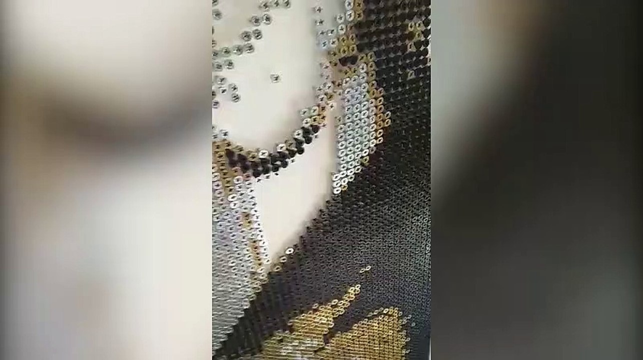 Darren Timby screws in the last screw of his Elvis Presley artwork ...