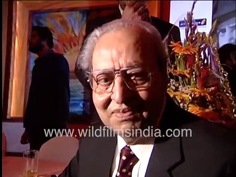 Actor Pran grins with child-like enthusiasm, peering with glee at the ...