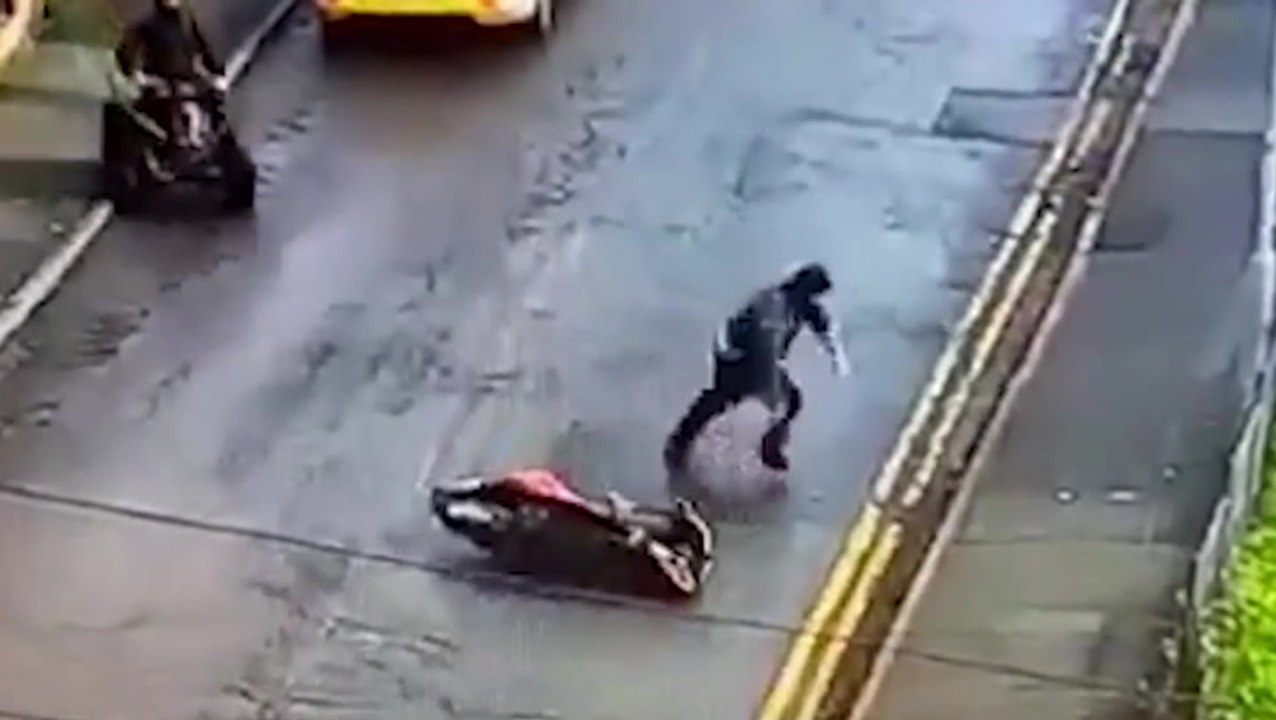 Moment man falls off scooter while trying to kick police car in Wales ...