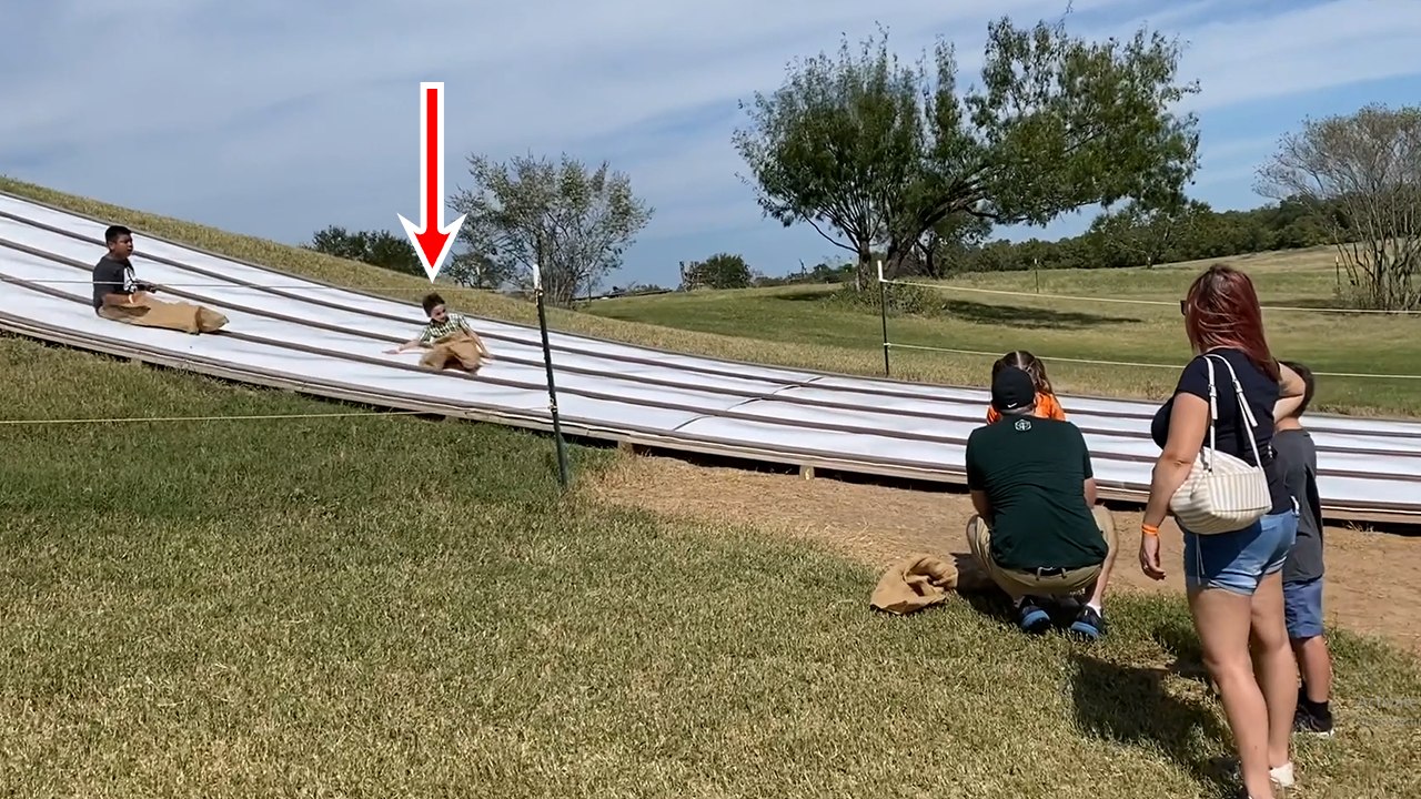Eager boy finds potato sack slide to be a bit too adventurous for his ...