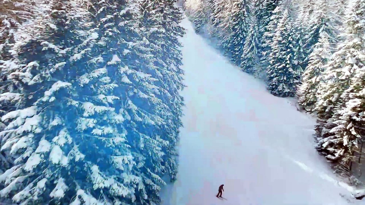 Aerial footage of skiers skiing down the mountain (4K Video Ultra HD ...