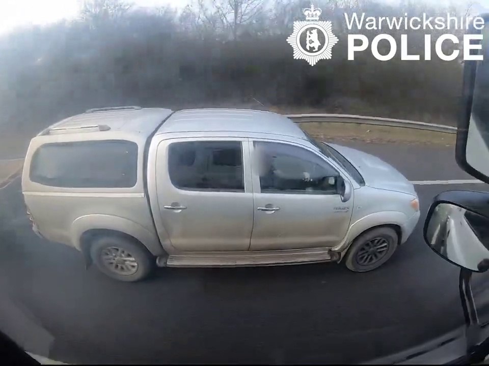 Motorists caught on camera driving along motorway while watching films ...