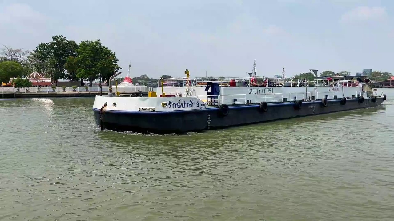 White container ship passing Koh Kret island at Chao Phraya river in ...
