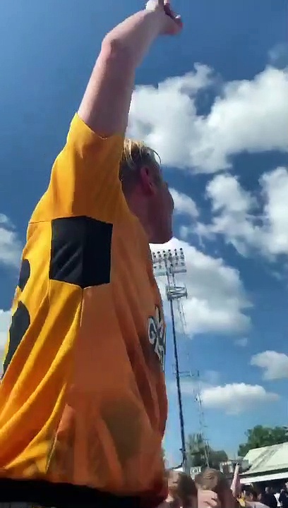 Cambridge United's Liam Bennett is lofted on a supporter's shoulders ...