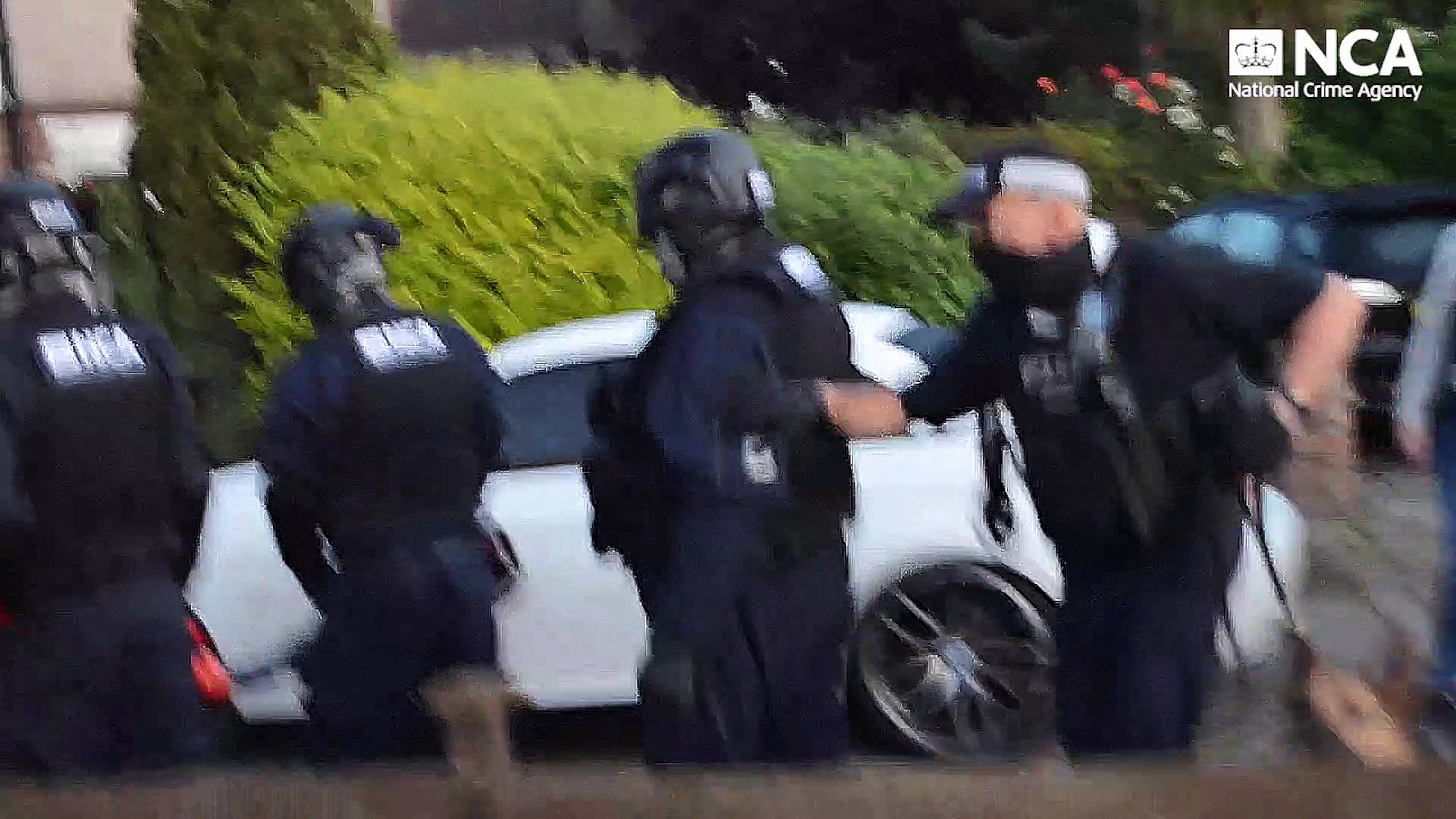 Moment officers raid people smuggling suspects