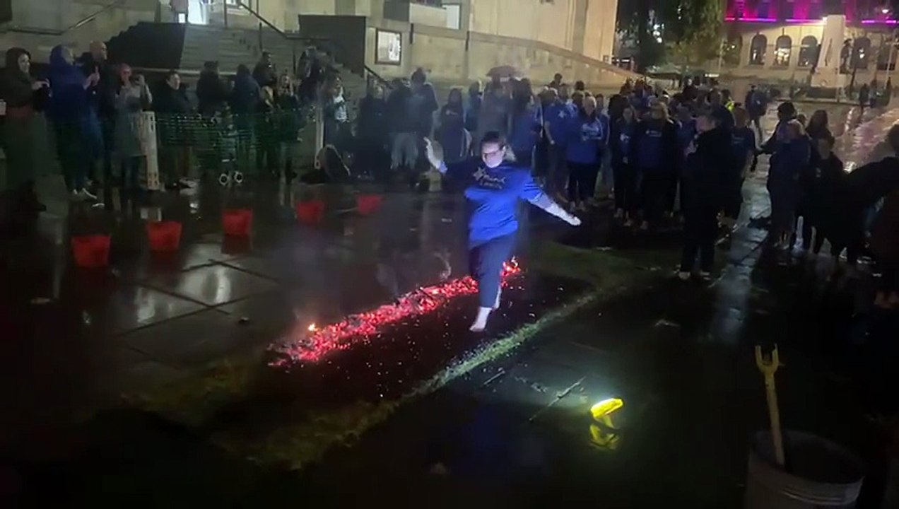 Dozens of people brave walking over hot coals in Leeds city centre for ...