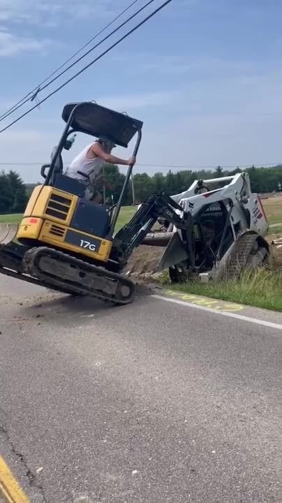 Mini Excavator Nearly Flips Over While Pulling Skid Steer up - video ...