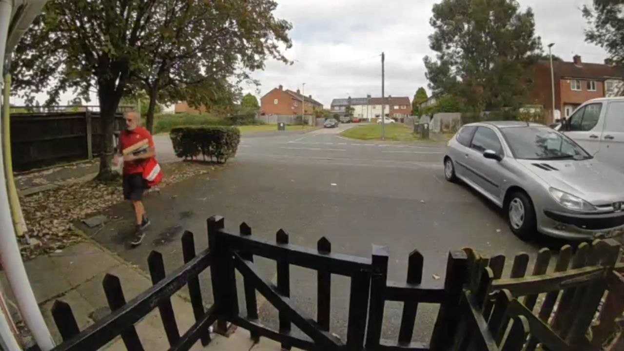 Comedic scene: Dog runs to greet the postman who quickly turns and runs ...