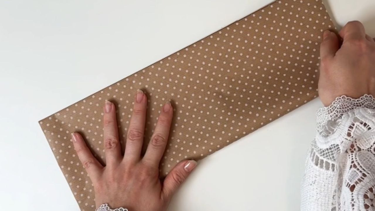 Girl creates a chic gift bag with wrapping paper and folds - video ...