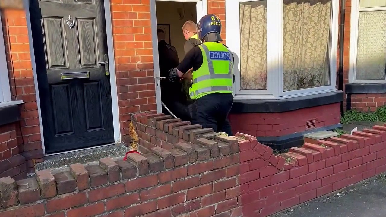 Police break down door and discover secret cannabis farm hidden behind ...