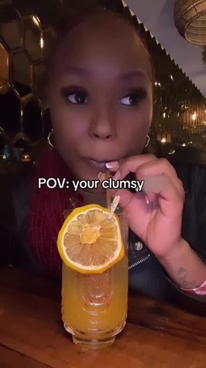 Woman Accidentally Knocks Over Her Glass of Drink With Her Hand - video ...