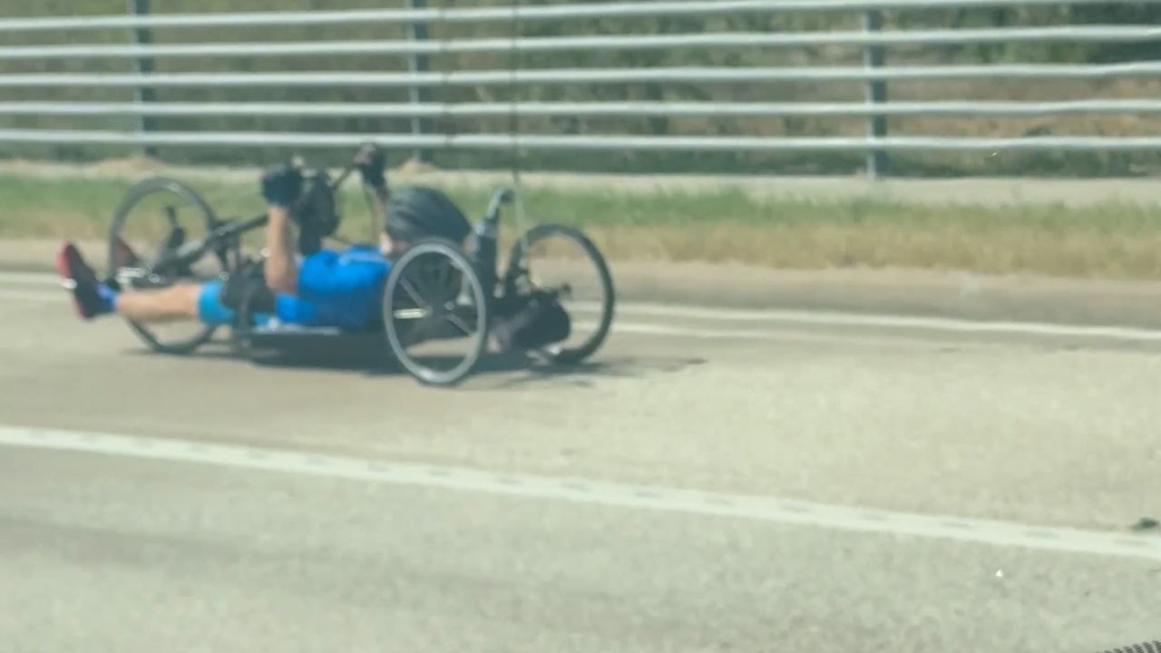 Funny video shows a man casually riding his bicycle while lying down on ...