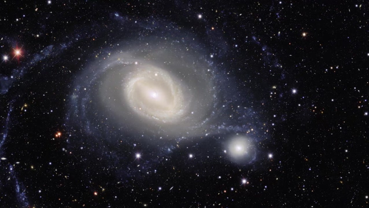 Spiral Galaxy Arm Wraps Around Companion In Amazing Imagery - video ...
