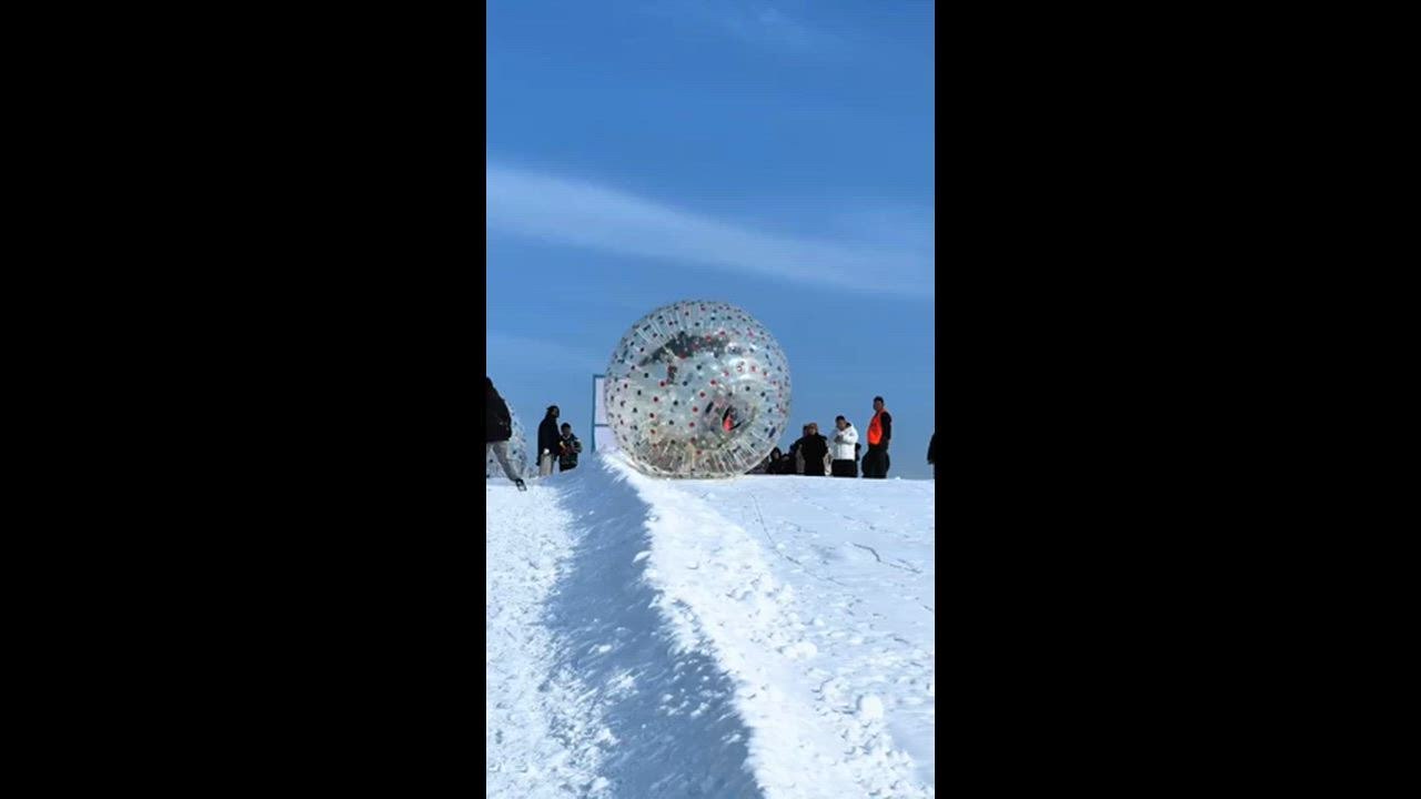 China: Inflatable snowball ride sends two Chinese visitors rolling down ...
